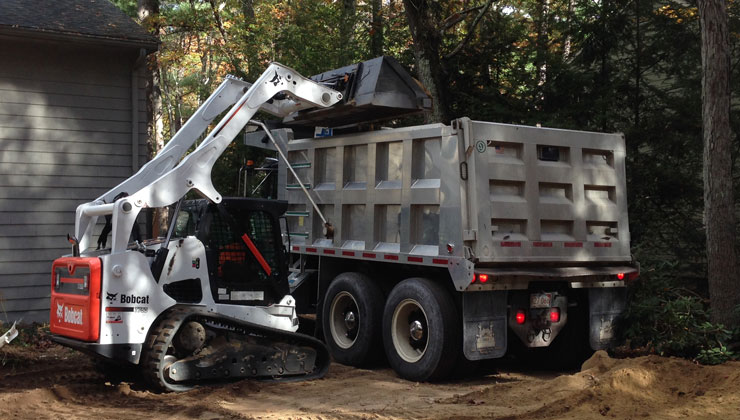 bobcat-loading-truck | Milestone Landscaping